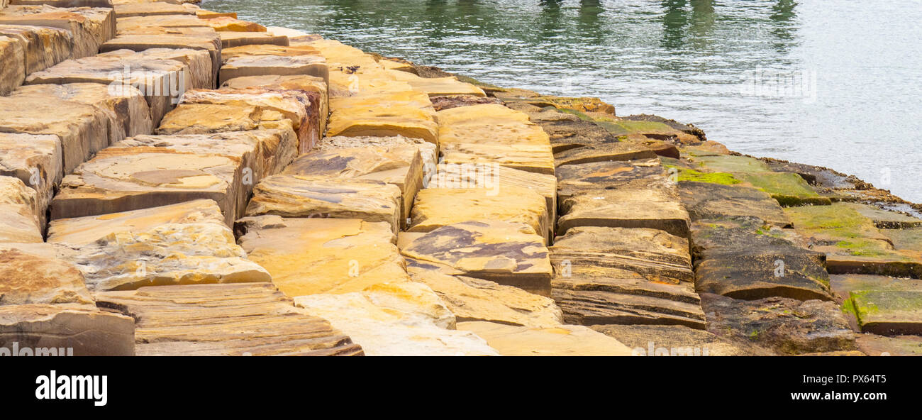 Large sandstone blocks laid out to create steps into the Nawi Cove ...