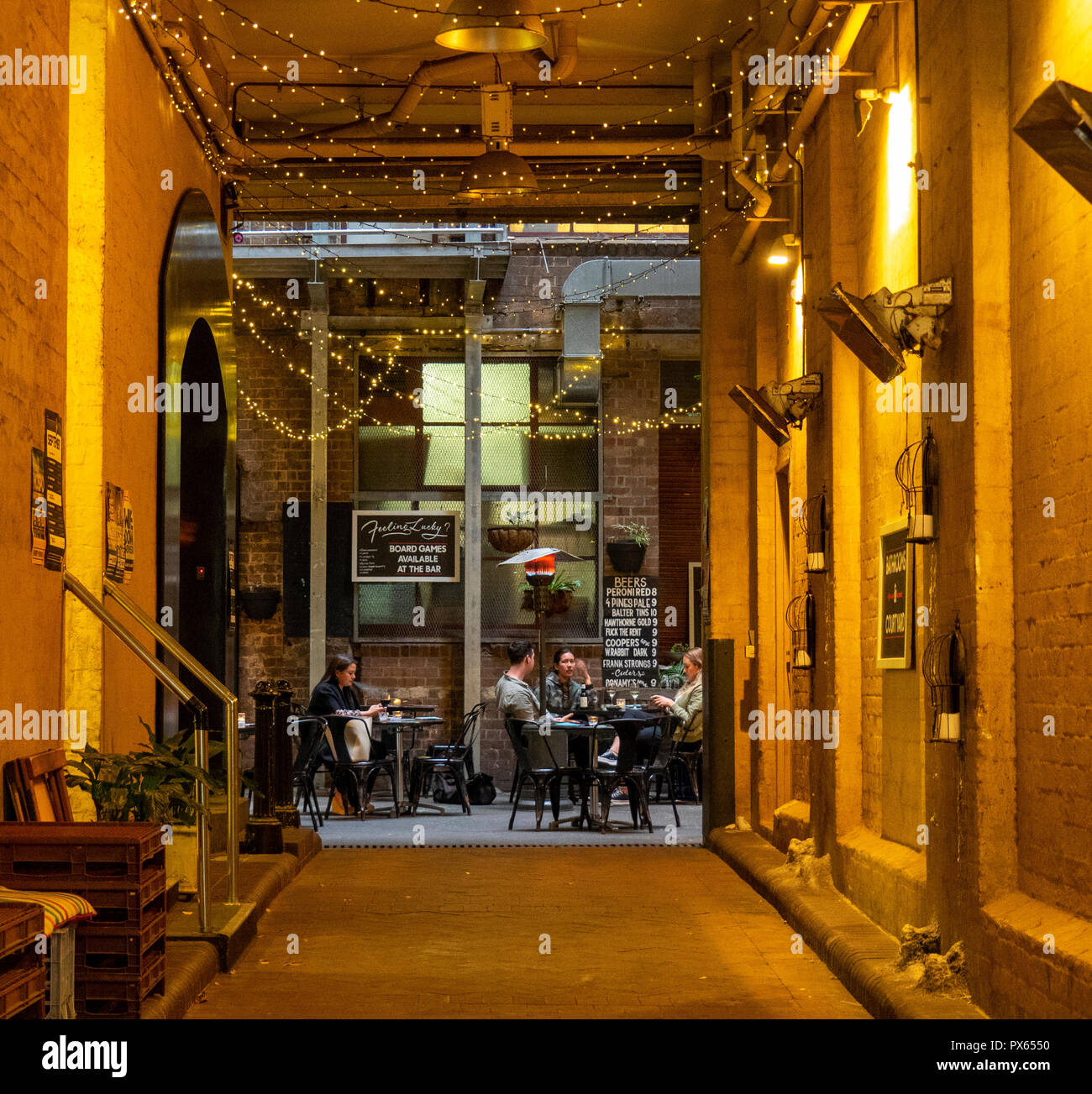 Alley laneway leading to a restaurant al fresco dining in a courtyard ...