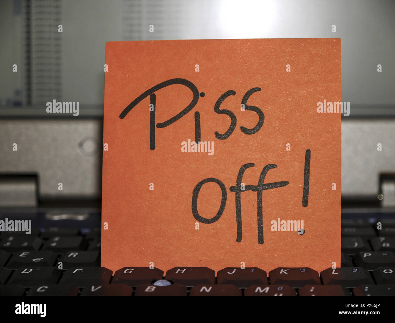 Memo note on notebook, piss off Stock Photo - Alamy