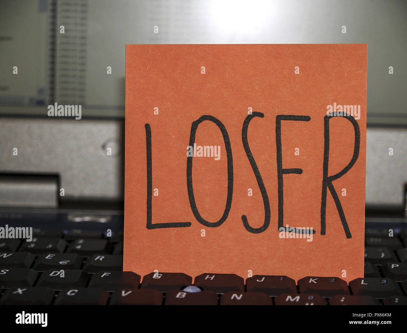 Memo note on notebook, loser Stock Photo - Alamy