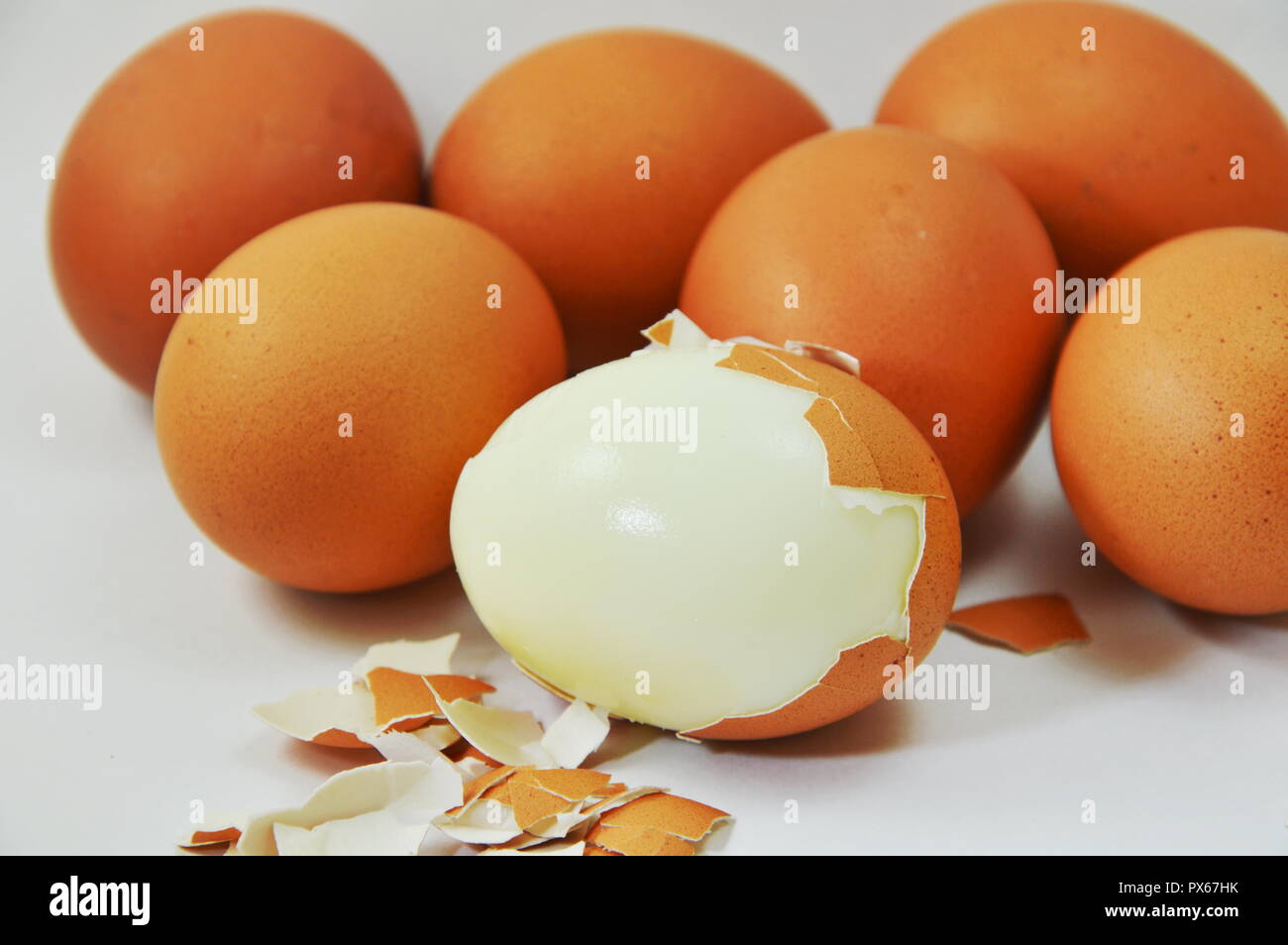 boiled egg peel shell out on white background Stock Photo - Alamy