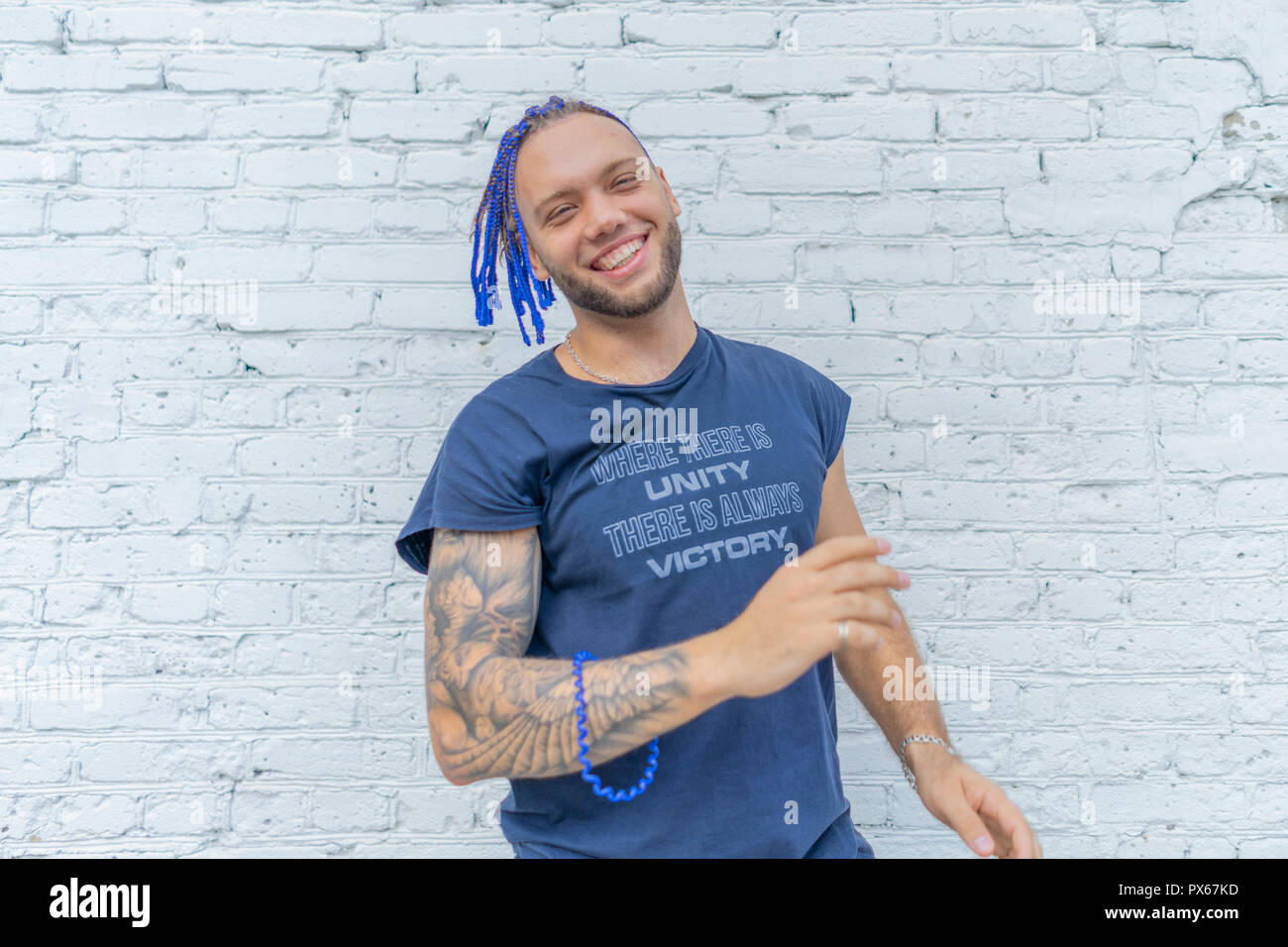 Young attractive man with blue dreadlocks smiling to camera Stock Photo ...