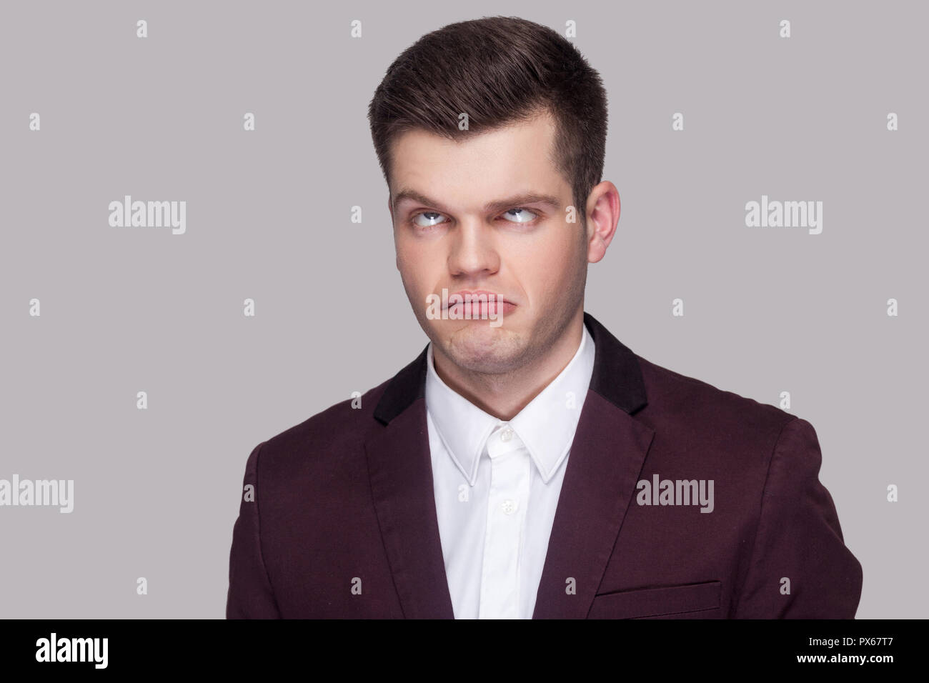 Portrait of funny crazy handsome young man in violet suit and white ...