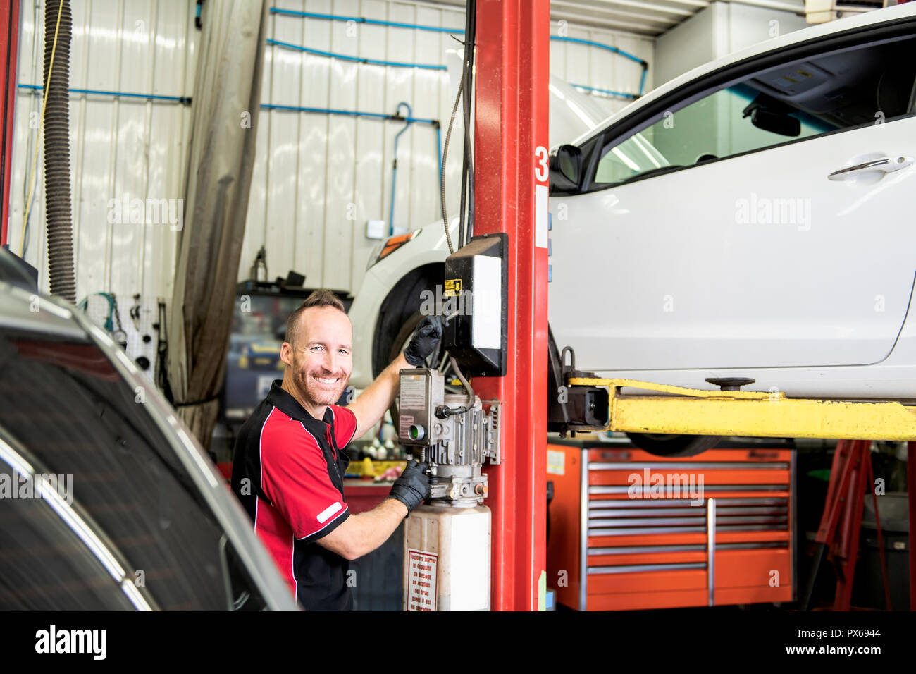 Handsome mechanic fixing tire in hi-res stock photography and images ...