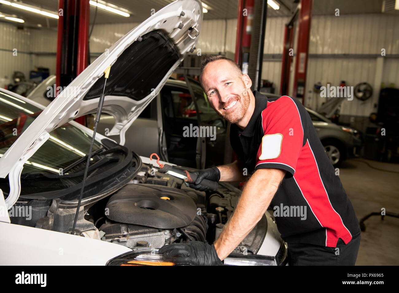 Handsome mechanic fixing tire in hi-res stock photography and images ...
