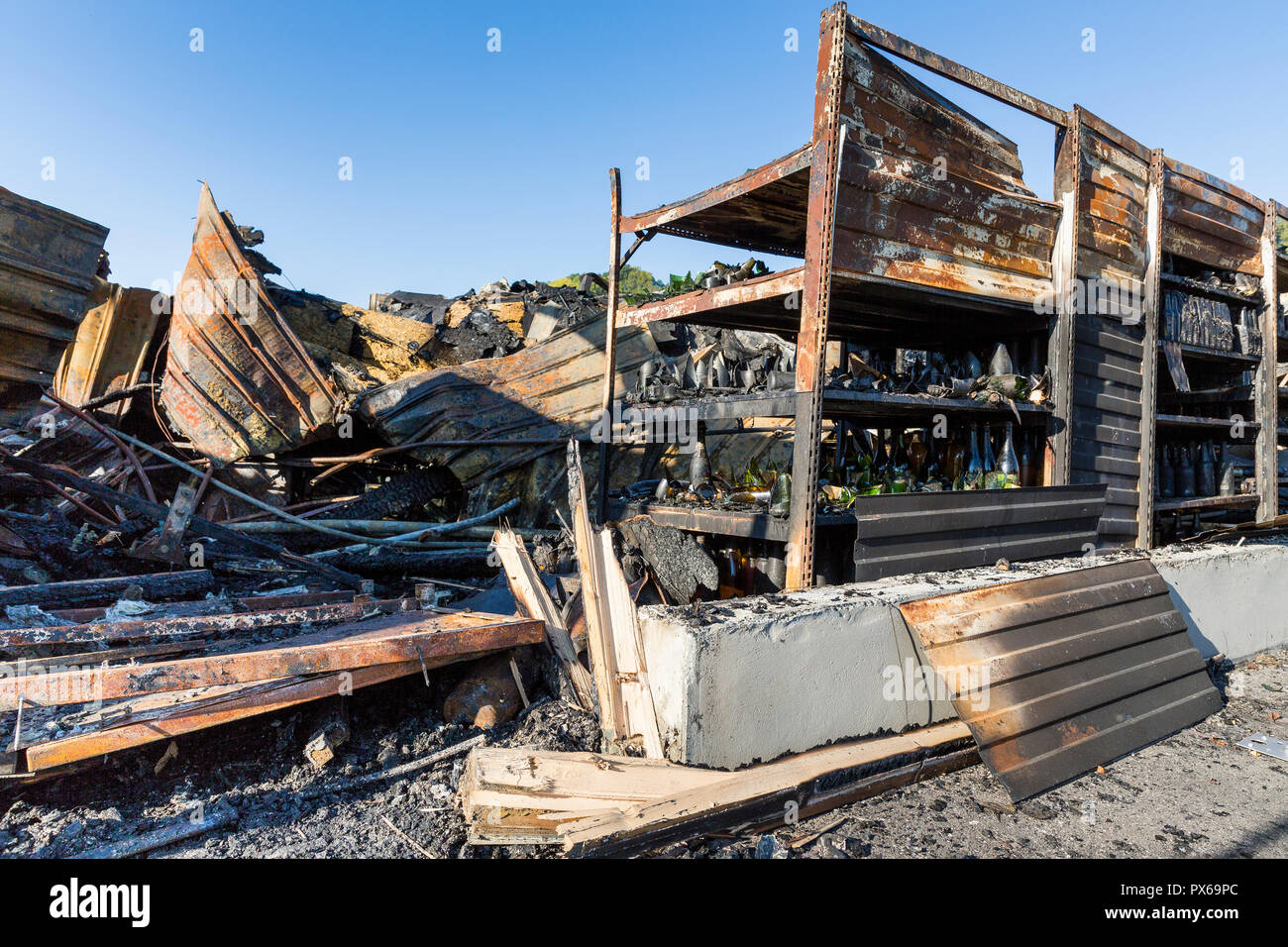 Damaged industry supermarket after arson fire with burn debris of ...