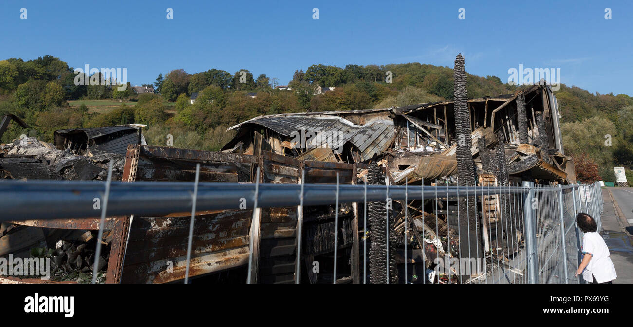 Damaged industry supermarket after arson fire with burn debris of ...