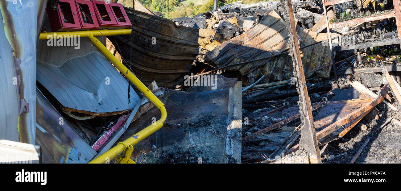 Damaged industry supermarket after arson fire with burn debris of ...