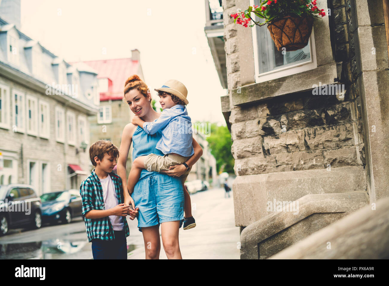 A mother with her two son outside in an urban street Stock Photo - Alamy