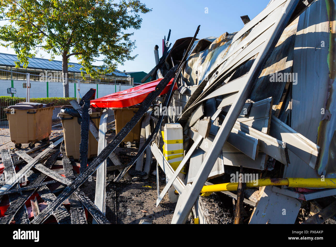 Damaged industry supermarket after arson fire with burn debris of ...