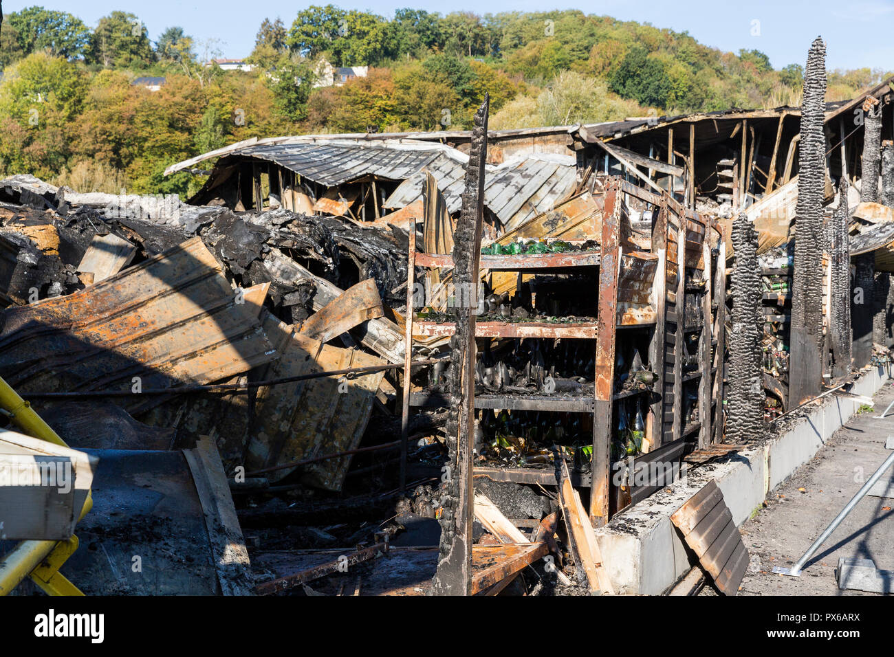 Damaged industry supermarket after arson fire with burn debris of ...