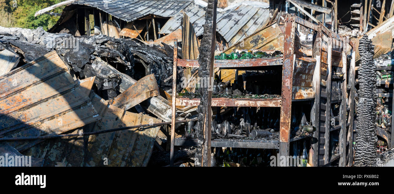 Damaged industry supermarket after arson fire with burn debris of ...