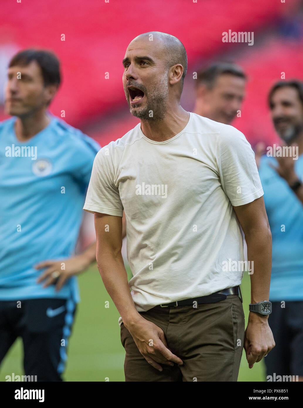 Man City Manager Pep Guardiola as his team lift the trophy during the ...