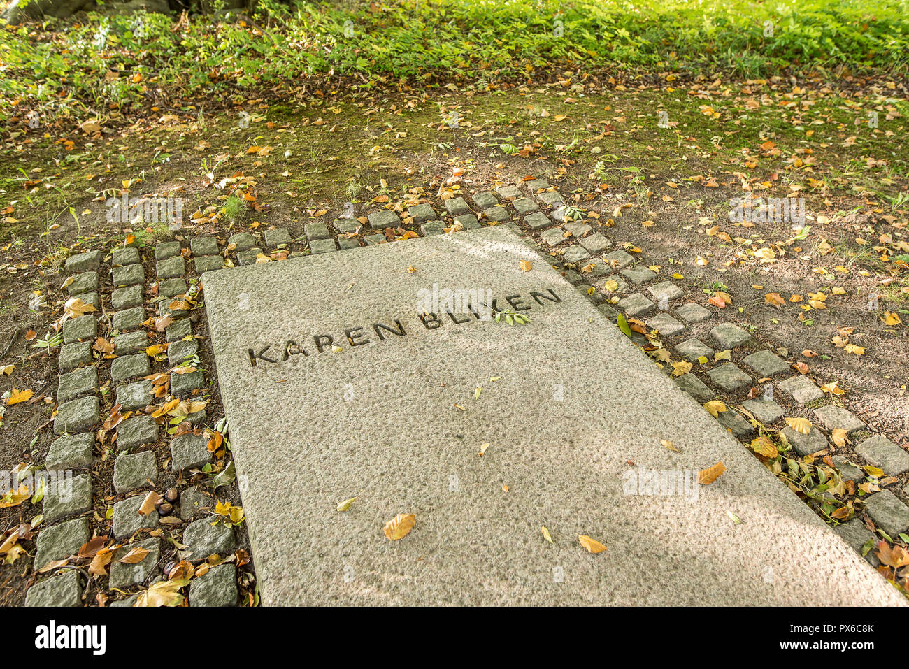 The headstone of the famous danish writer Karen Blixen, with yellow ...