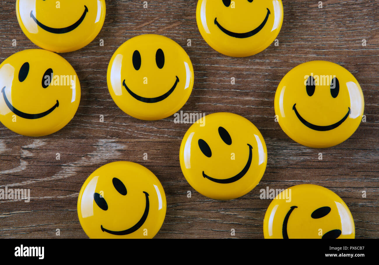emoticon icons on wooden background top view Stock Photo - Alamy