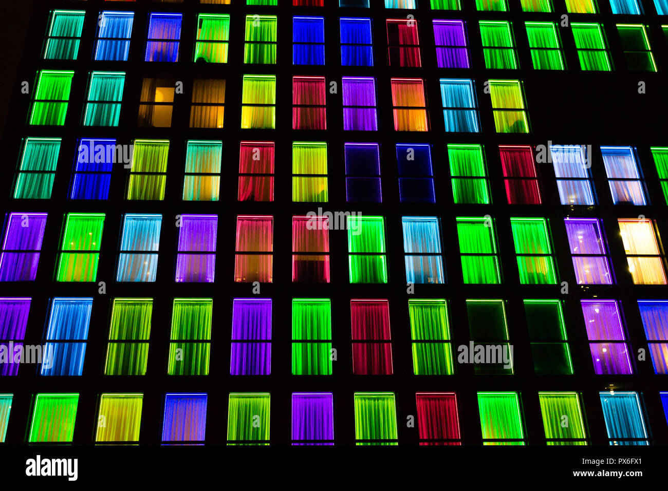 Colored windows texture. Windows illuminated by neon lights background ...