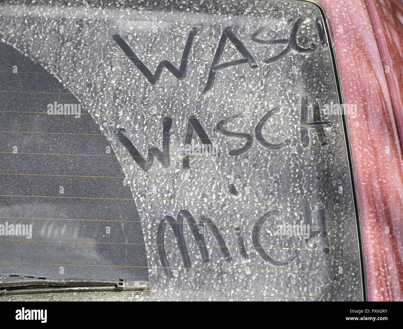 Wash me, dirty back window of a car Stock Photo - Alamy
