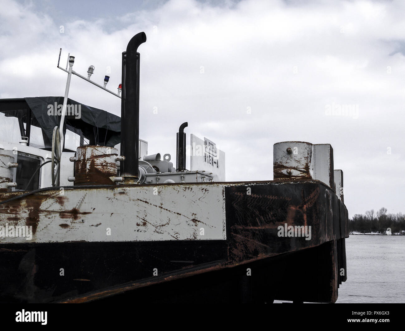 Rusty cargo ship at the river bank Stock Photo - Alamy