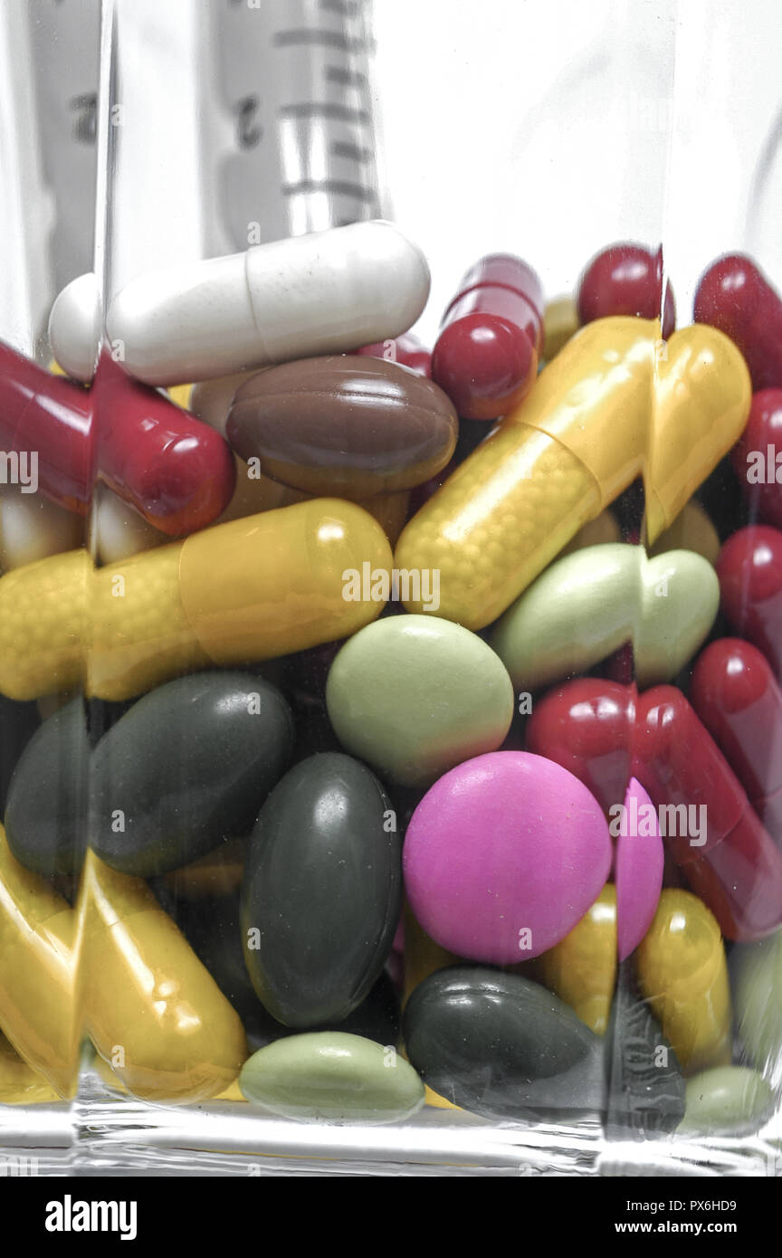 Pills and an injection Stock Photo - Alamy