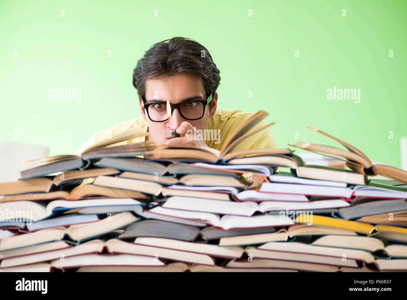 Student with too many books to read before exam Stock Photo - Alamy