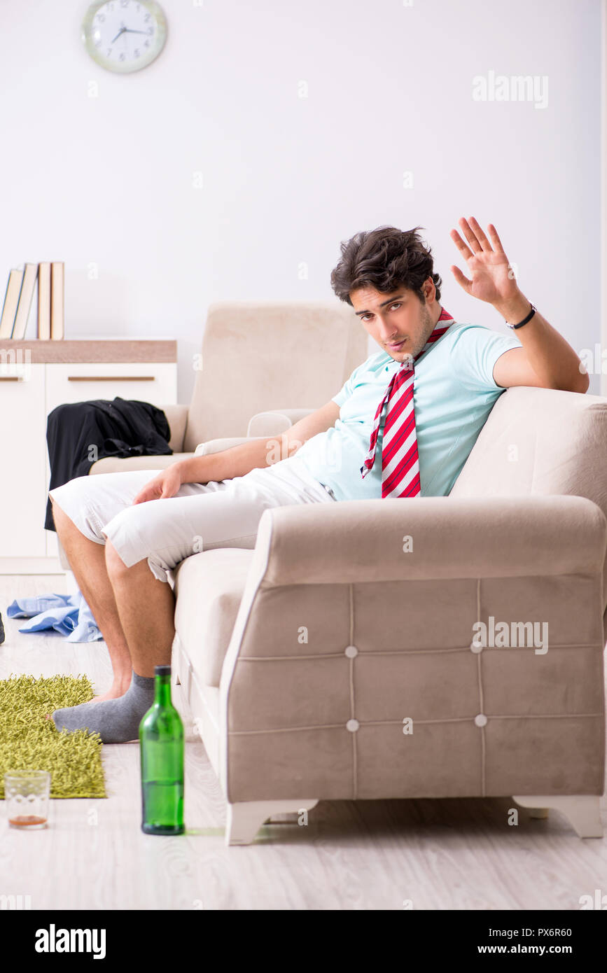 Young drunk handsome man after party at home Stock Photo - Alamy