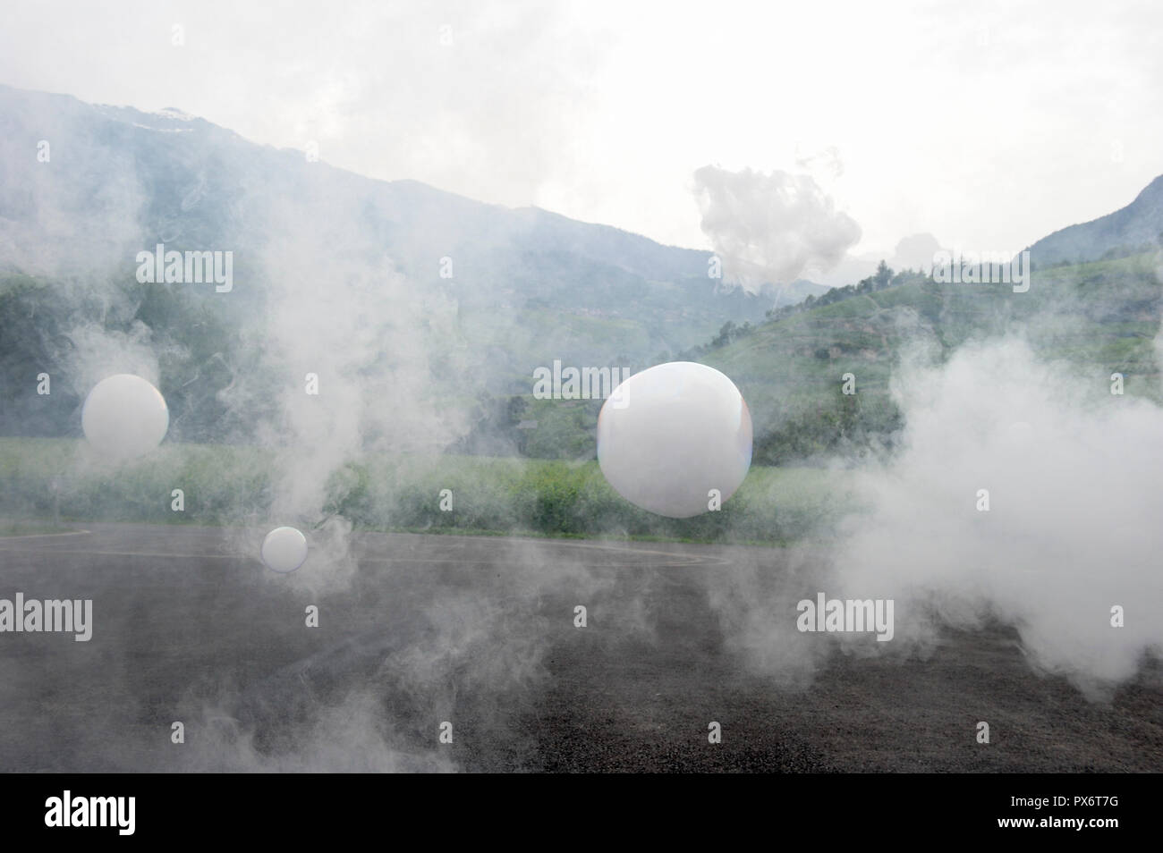 Switzerland, Wallis, artificial white air bubbles from bubble machine ...