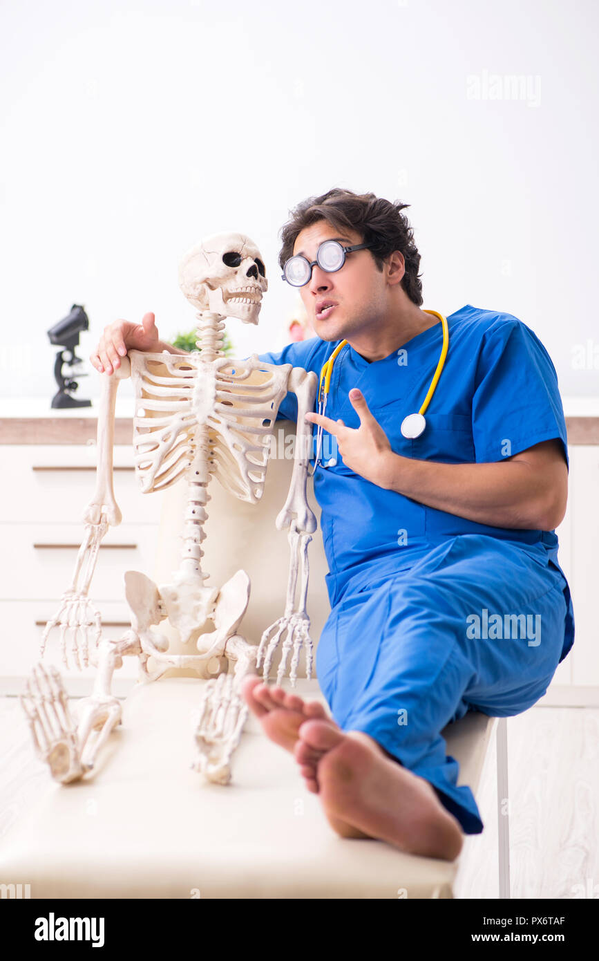 Funny doctor with skeleton in hospital Stock Photo - Alamy