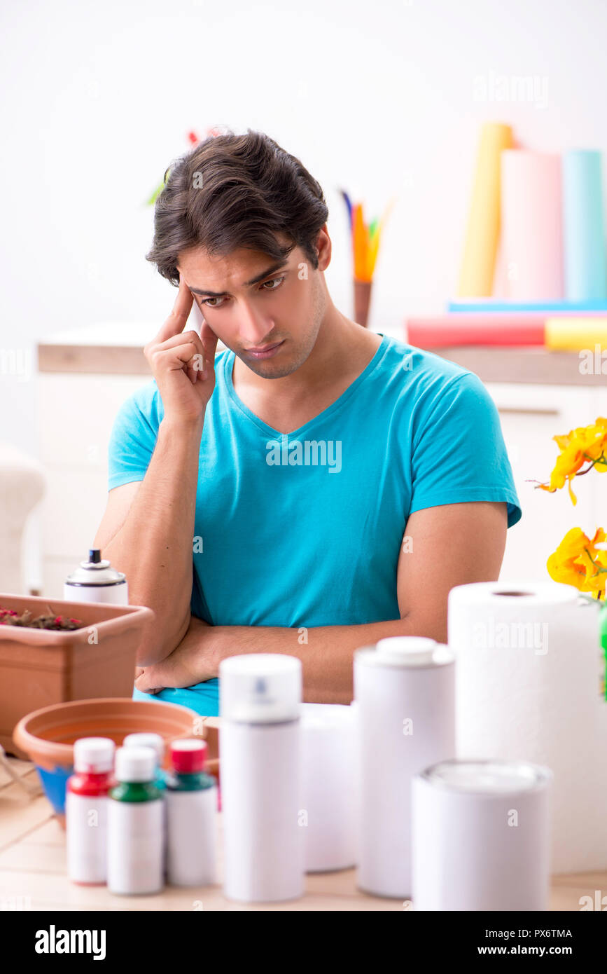 Young man decorating pottery in class Stock Photo - Alamy