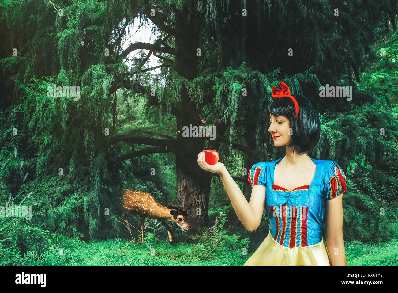 Snow White cosplay girl in the mysterious forest. Artistic processing ...