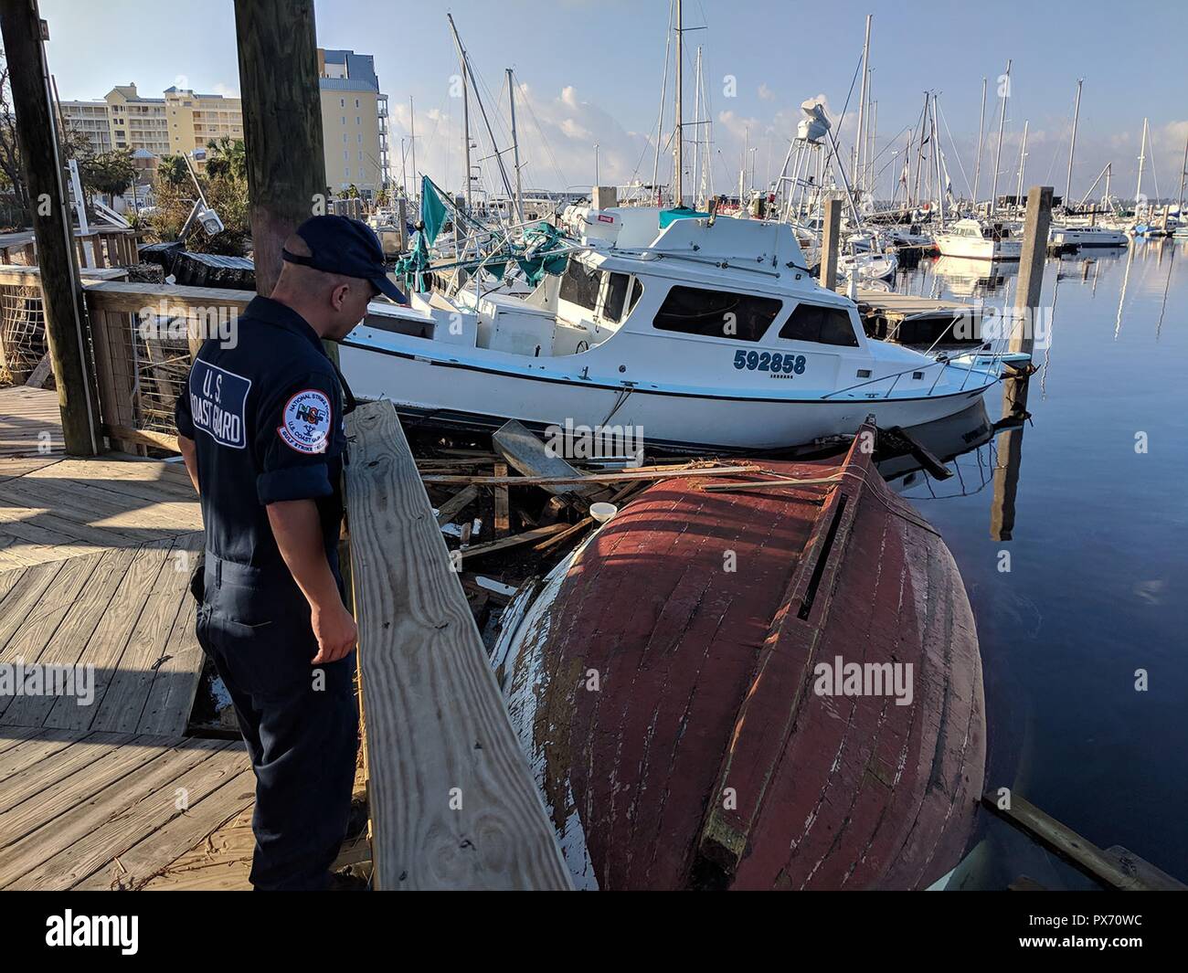 Catastrophic damage to a docks, boats and the marina in the aftermath ...