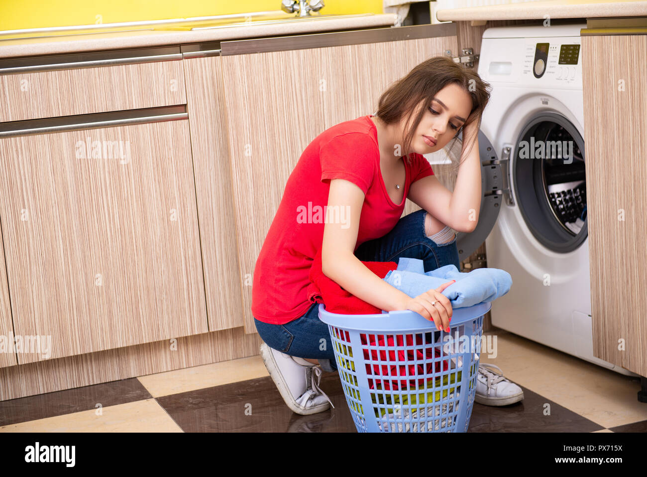 Woman doing laundry at home Stock Photo - Alamy