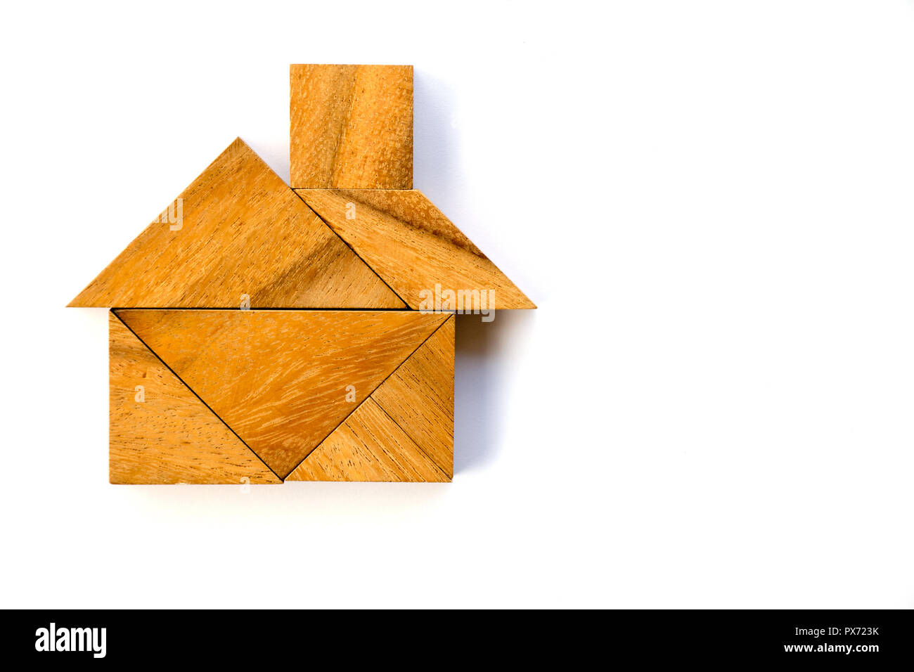 Wooden tangram puzzle in home shape on white background Stock Photo - Alamy