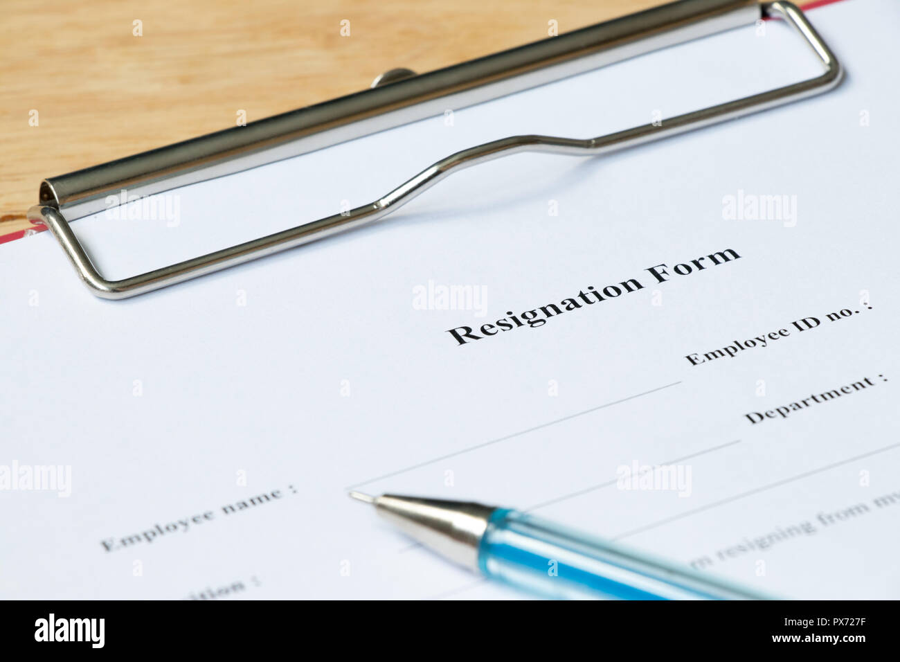Resignation form on wood desk background Stock Photo - Alamy
