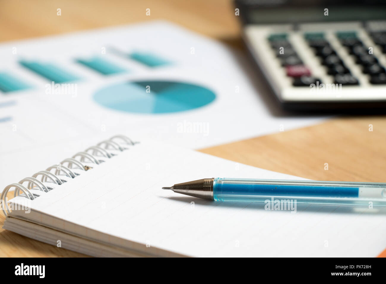 Note paper with pen, graph, calculator background Stock Photo - Alamy