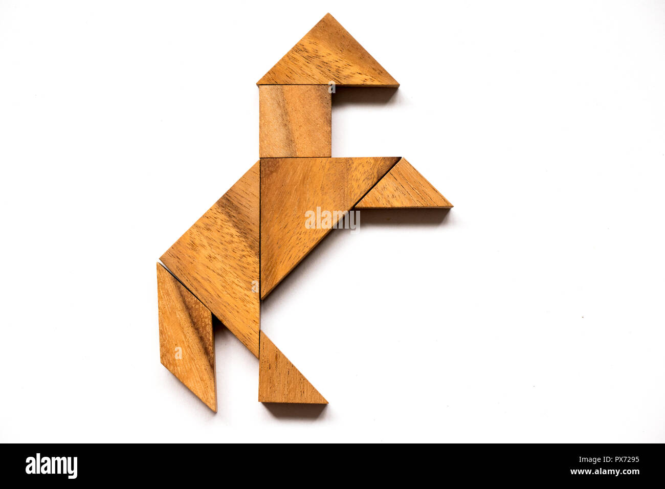 Wooden tangram in horse shape on white background (Concept for energy ...