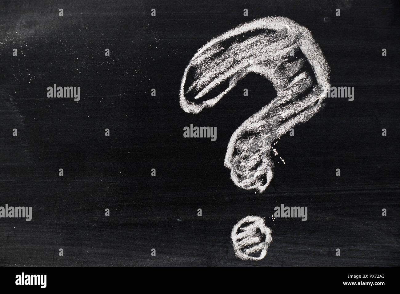 Chalk hand drawing as question mark shape on black board background ...