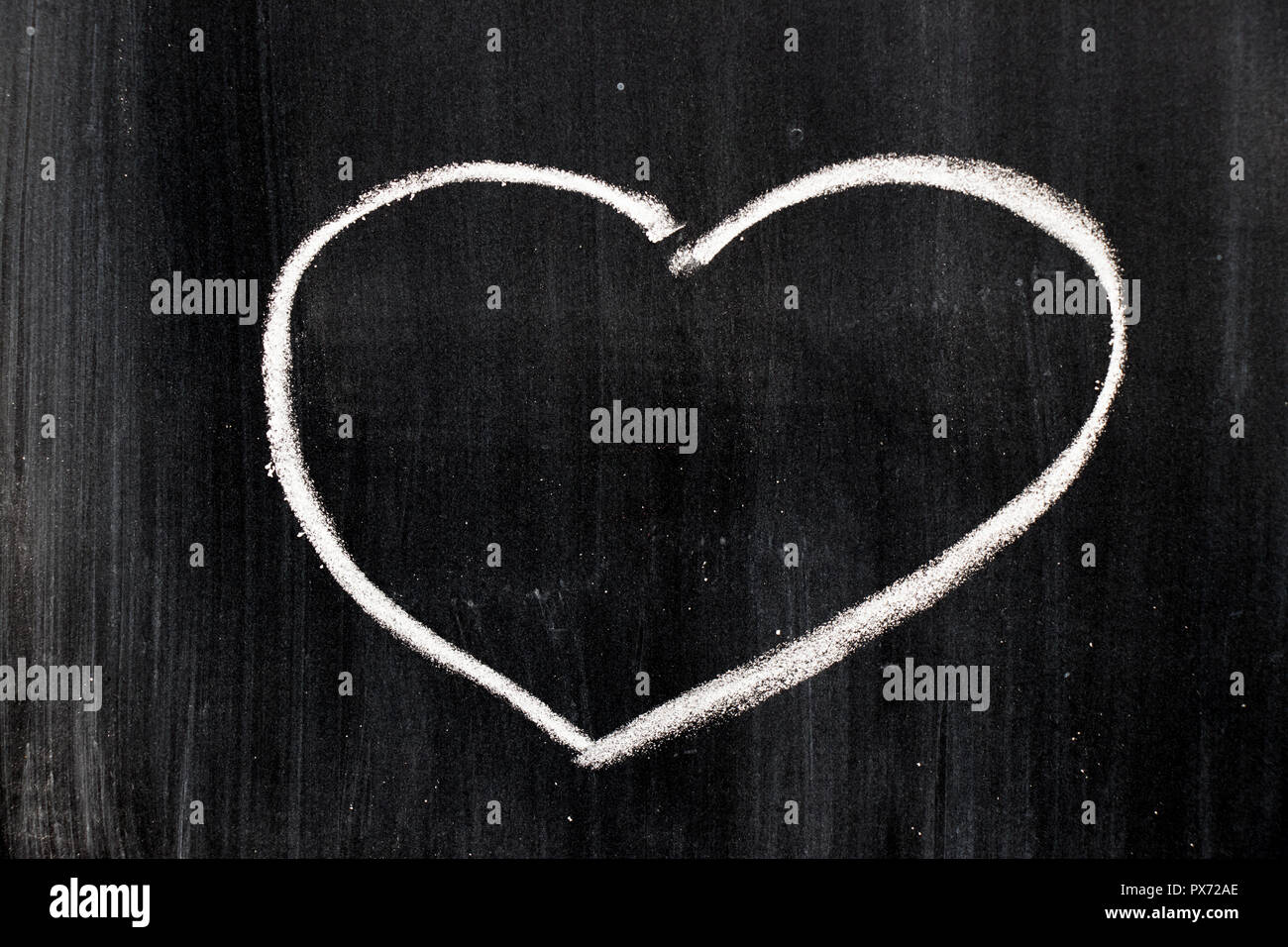 Chalk hand drawing as heart shape on black board background Stock Photo ...