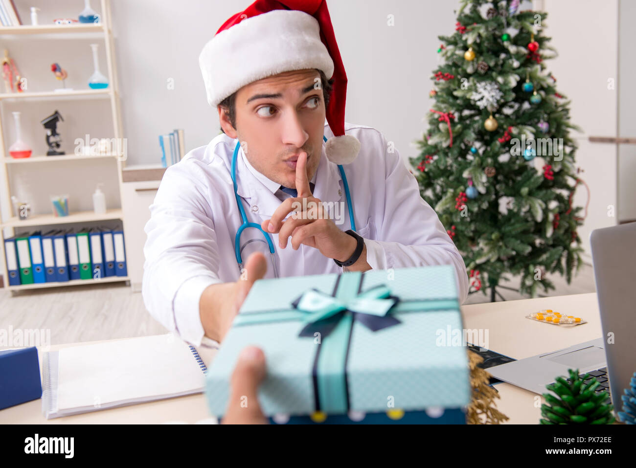 Doctor with gift box in the hospital Stock Photo - Alamy