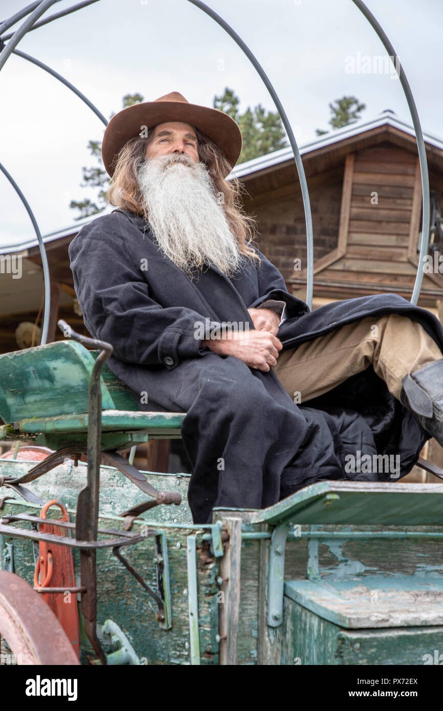 Western man in traditional clothing sitting on a wagen Stock Photo - Alamy