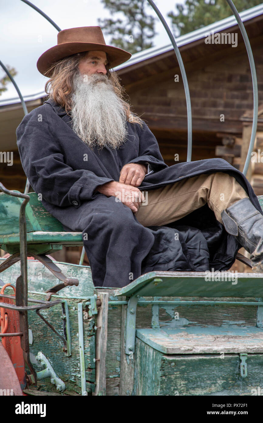 Western man in traditional clothing sitting on a wagen Stock Photo - Alamy