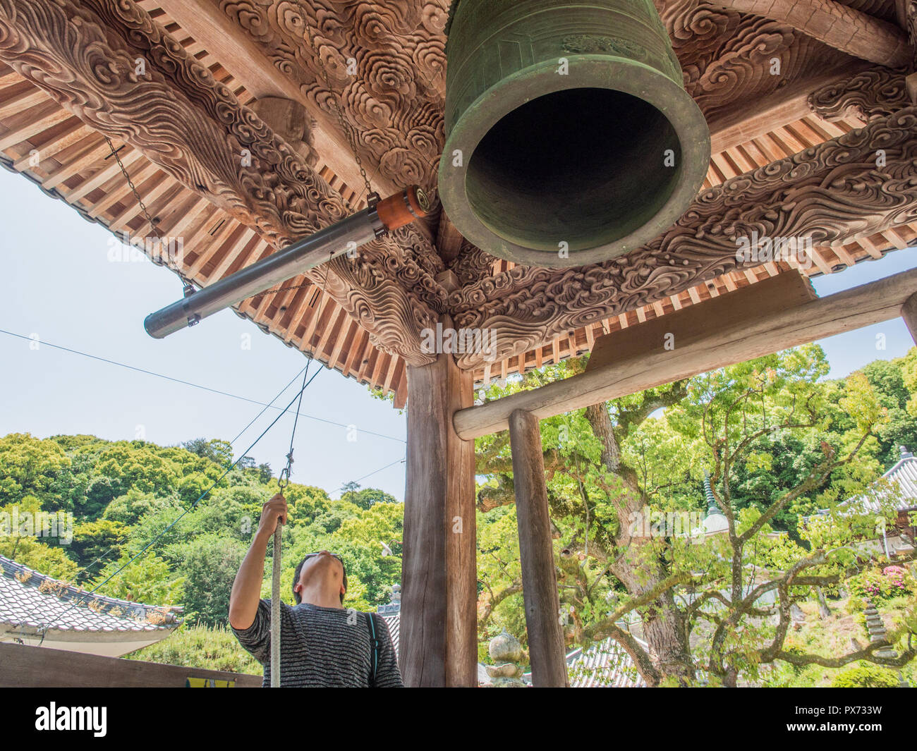 Man ringing temple bell, Kanonji temple, Kagawa, Shikoku, Japan Stock ...
