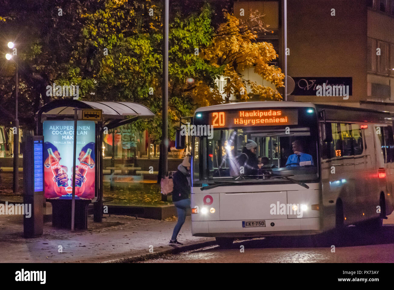 Bus stopped at bus stop at night in Oulu Finland Stock Photo - Alamy