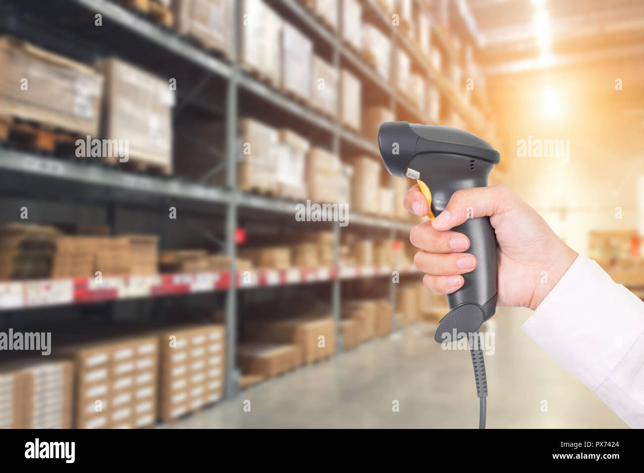 Worker checking and scanning package by laser barcode scanner in modern ...