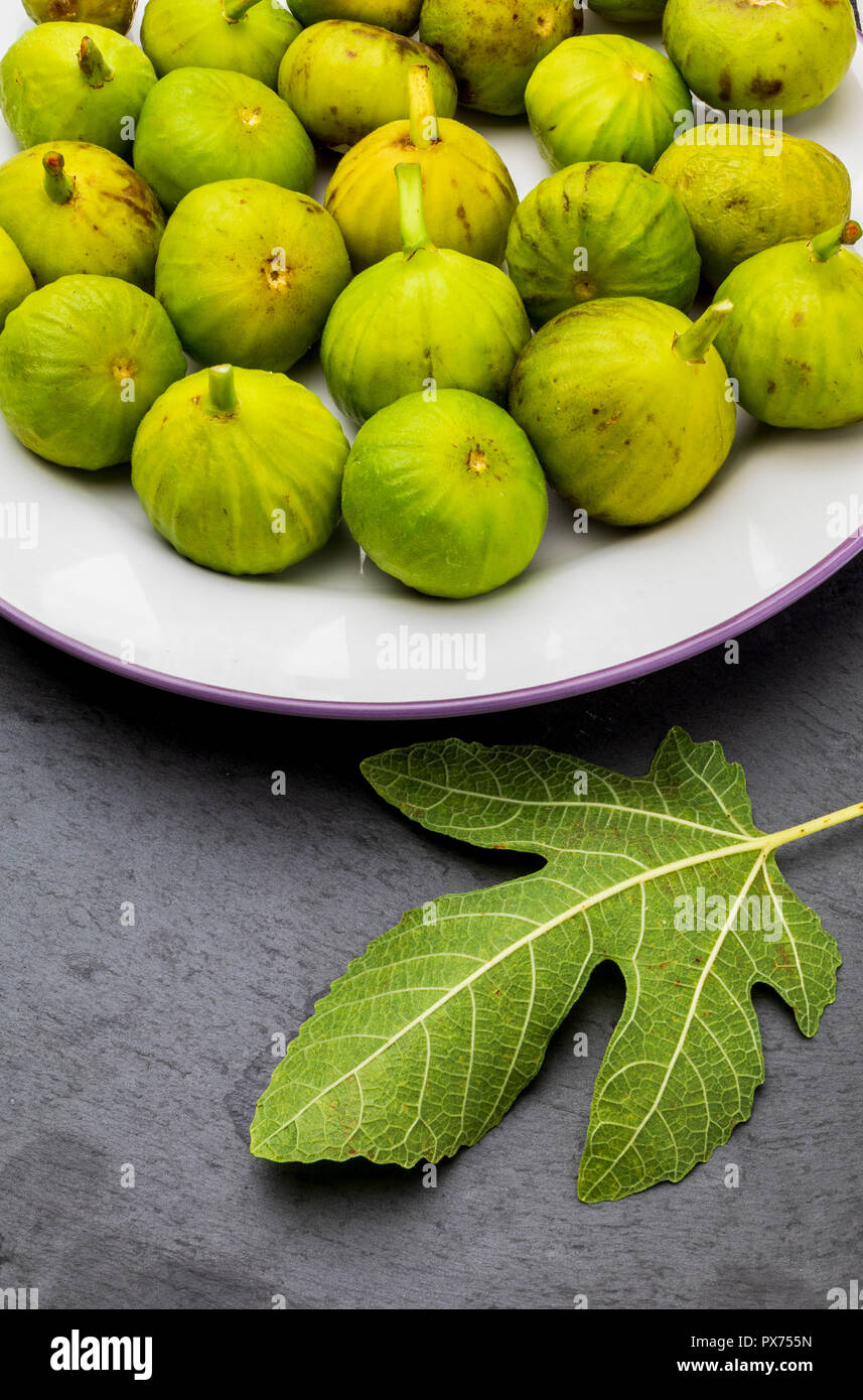 Green figs, fresh and ripe. With a fig leaf Wood background Stock Photo ...