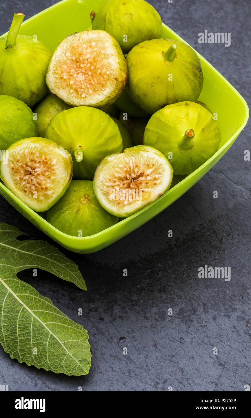 Green figs, fresh and ripe. With a fig leaf Wood background Stock Photo ...