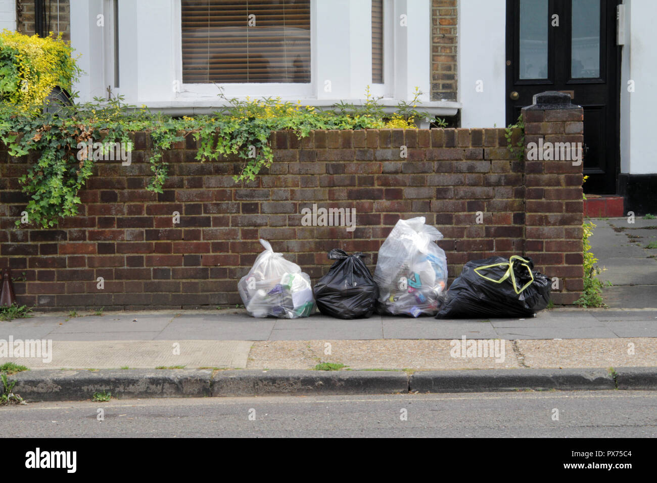 Filthy London street covered in Litter and rubbish bags Stock Photo - Alamy