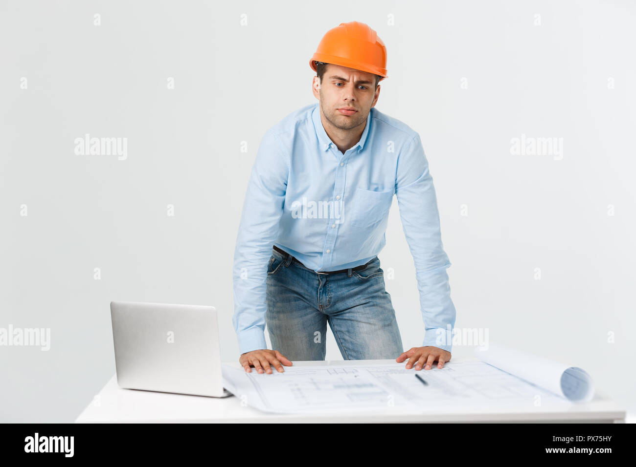 Portrait of confused male designer or architect, feels stressed, being ...