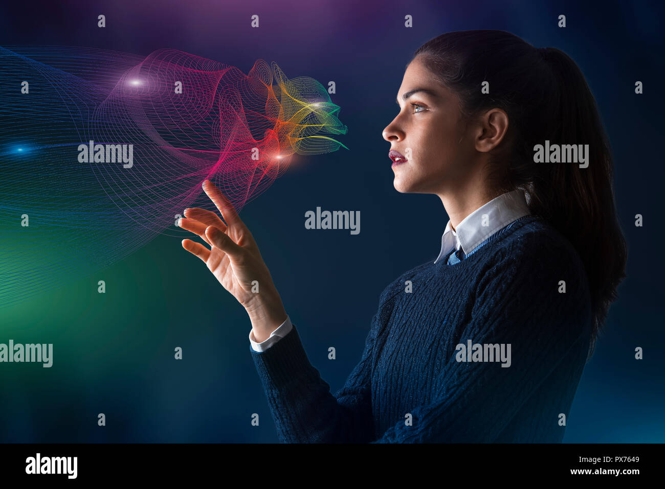 concept of a young woman selecting colors on projected rainbow color ...