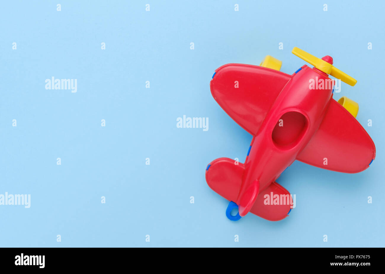 Toy children's red plane on a blue background, top view Stock Photo - Alamy
