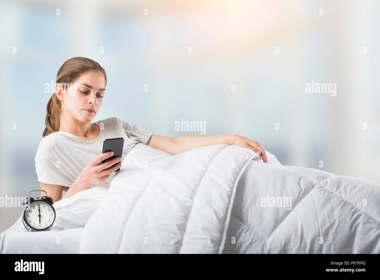Woman bed phone waking up hi-res stock photography and images - Alamy